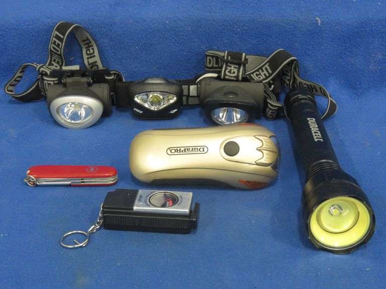 Three head flashlights, a Duracell flashlight, a hand crank light, a ...