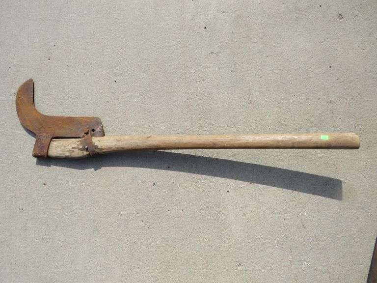 Long-handled tools and a short-handled paddle, plus one ski, and an ...