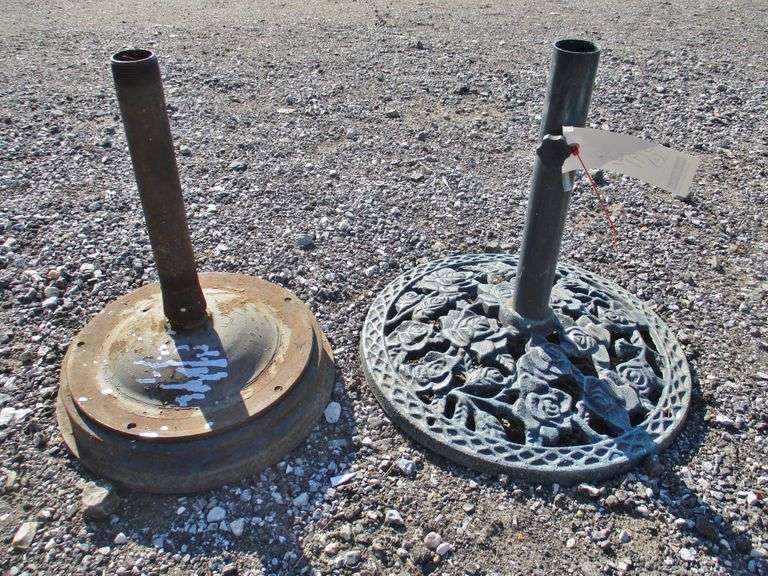 (2) Heavy pipe umbrella stands - Albrecht Auction Service