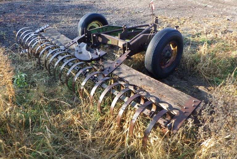 Spring tooth drag harrow with 15" tires, harrow pivots down from frame ...