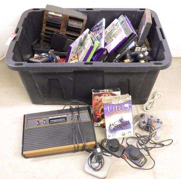 Tote of old video game stuff - Albrecht Auction Service