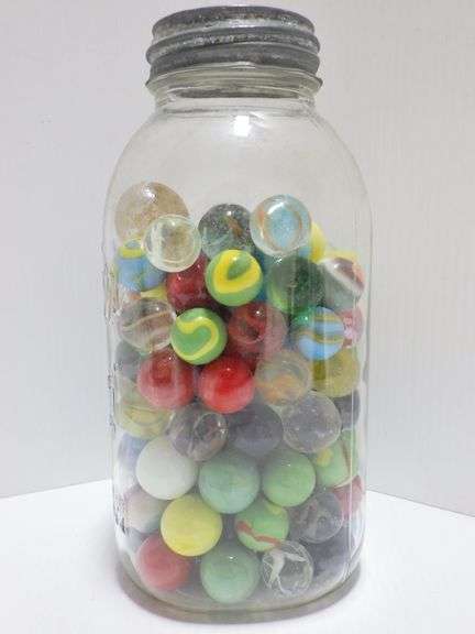 Over (100) Marbles in a half-gallon jar - Albrecht Auction Service