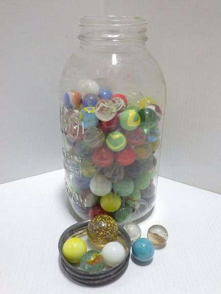Over (100) Marbles in a half-gallon jar - Albrecht Auction Service