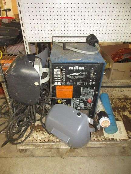 Miller Arc welder, including: (3) Helmets, (2) Hammers, and cables ...