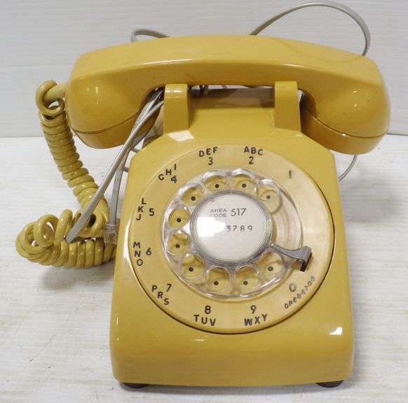 Older cream/yellow dial up phone with plug in line, still works ...