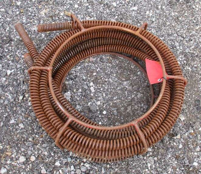 Old metal drain snake, rusty - Albrecht Auction Service