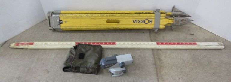 Transit, tripod, and grade pole - Albrecht Auction Service