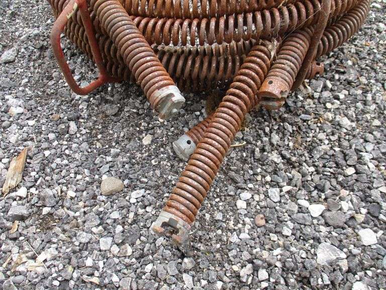 Old metal drain snake, rusty - Albrecht Auction Service
