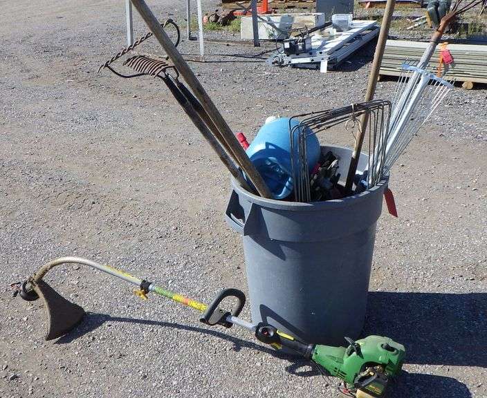 Trash can with garden tools, (5) Gas cans, John Deere weed wacker with ...
