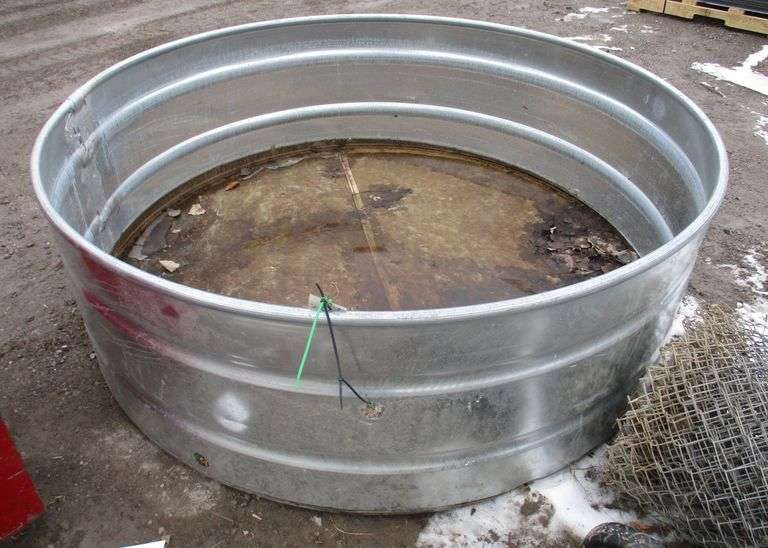 Galvanized steel water tank, 390-gallons, 6'W x 2'H, has two holes in ...