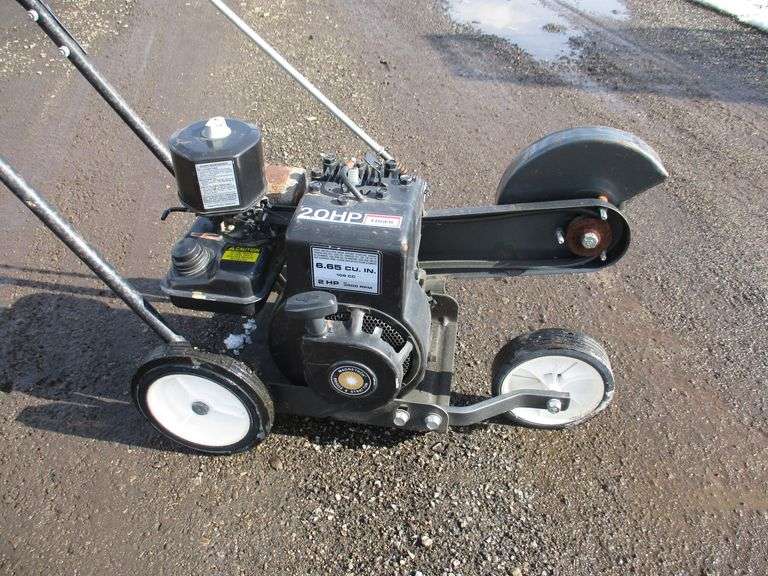 White outdoor sidewalk edger, 2 HP Briggs engine, good blade and belt ...