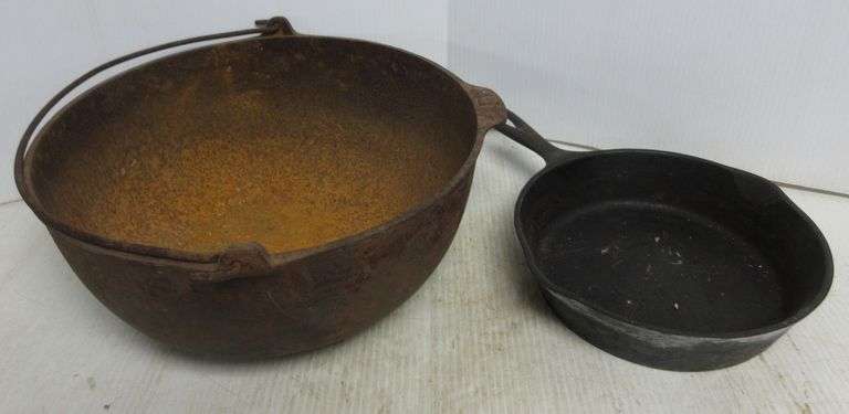 Antique cast iron pot with handle and small skillet, pot is rusted ...