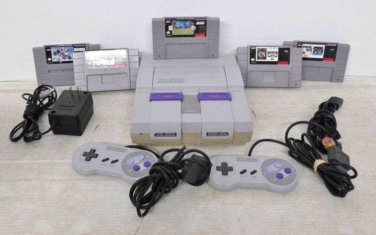 Super Nintendo, (2) controllers, (5) games, and all cords, 12" x 8" x ...