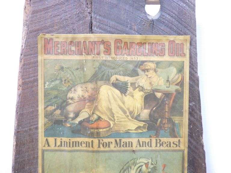 Paper advertising poster for Merchant's Gargling Oil pasted on an old ...