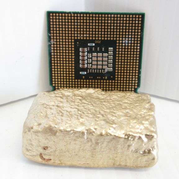 Melted computer chips bar, has gold and other metal in it and a regular ...