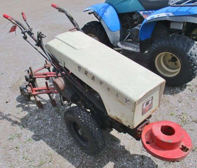 Antique gravely garden tractor with attachments, engine rolls over and ...