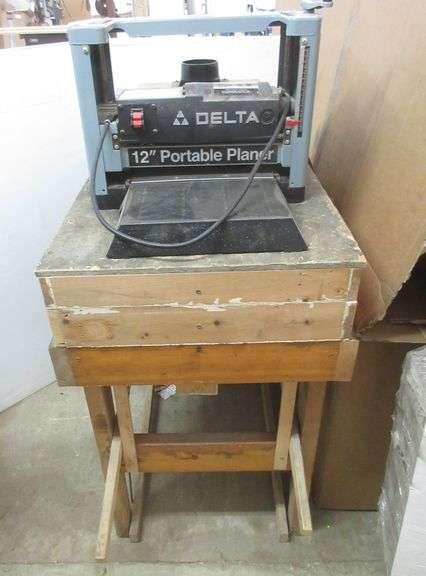 Delta 12" planer with extra set of new blades on a mobile cart with ...