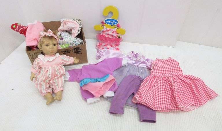 Pouting baby doll with large amount of clothes, 9"L - Albrecht Auction ...