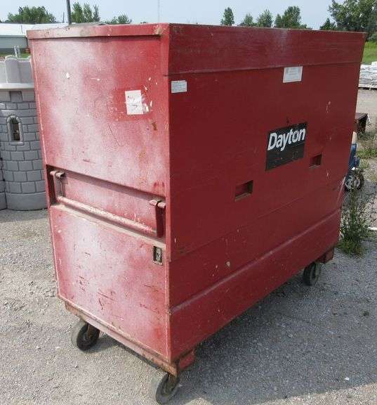 Maroon Dayton job box with four wheels, has two-shelves in it, one ...