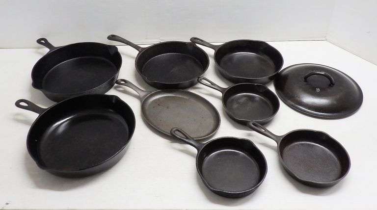 (9) Older cast iron pans and lids, includes: 10" oval pan, 10" pan, 12 ...