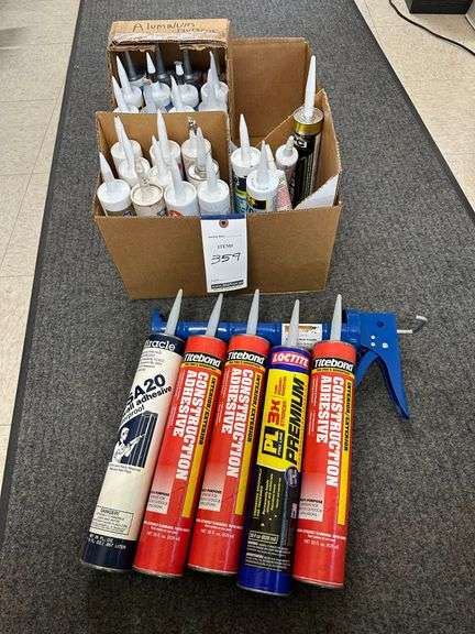 Box full of construction adhesives, caulks and sealants. Includes large ...
