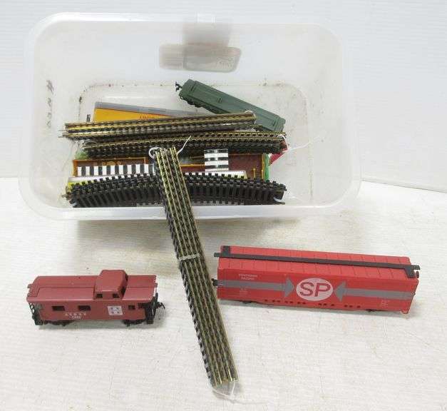 Toy train whistle house, HO scale cars and engine, and HO tracks ...