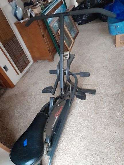 Black health rider exercise bike in upstairs room - Advantage Auction