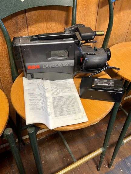 Old camcorder with battery and chargee - Baker Auctions & Real Estate, LLC