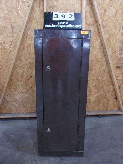 BROWN VERTICAL METAL GUN LOCK BOX - Bentley & Associates, LLC