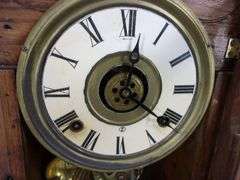 WOOD FRAMED FREE STANDING CLOCK - Bentley & Associates, LLC