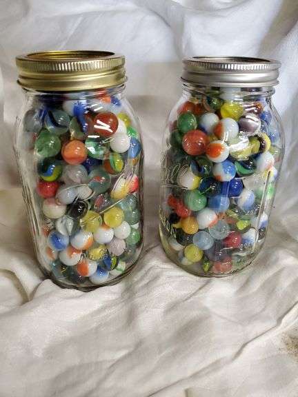 Two glass jars assorted marbles. X2 - Bid-Assets Online Auctions