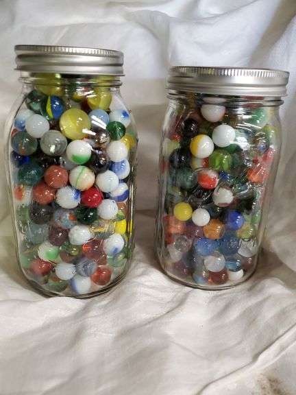 Two glass jars assorted marbles. X2 - Bid-Assets Online Auctions