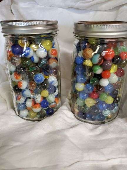 Two glass jars assorted marbles. X2 - Bid-Assets Online Auctions