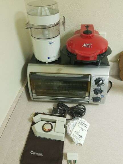 Group of kitchen appliances including Oster juicer, Express ready set ...