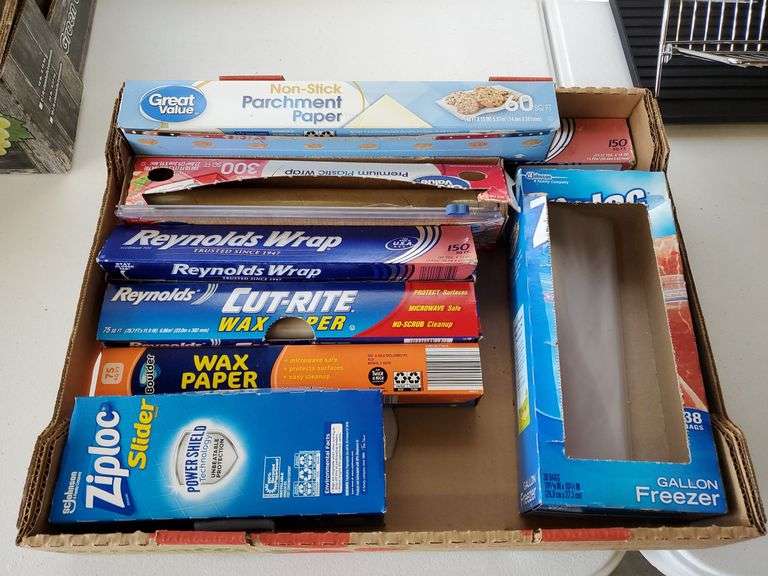 Box of assorted aluminum wrap, wax paper, Ziploc bags, and parchment ...