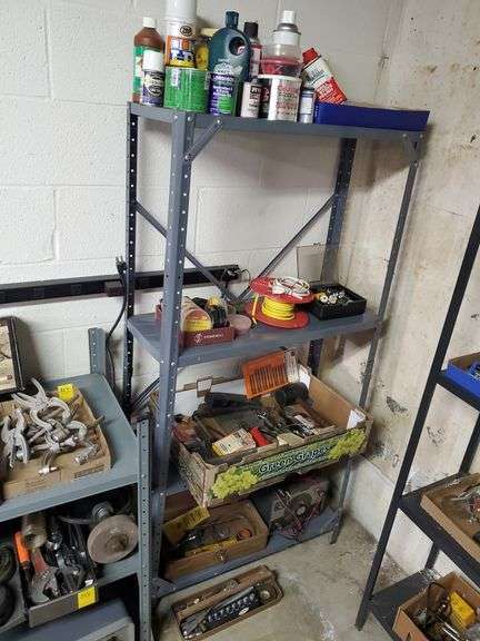 Grey metal shelf with 2 cycle oil, grease, electrical tape, wire ...