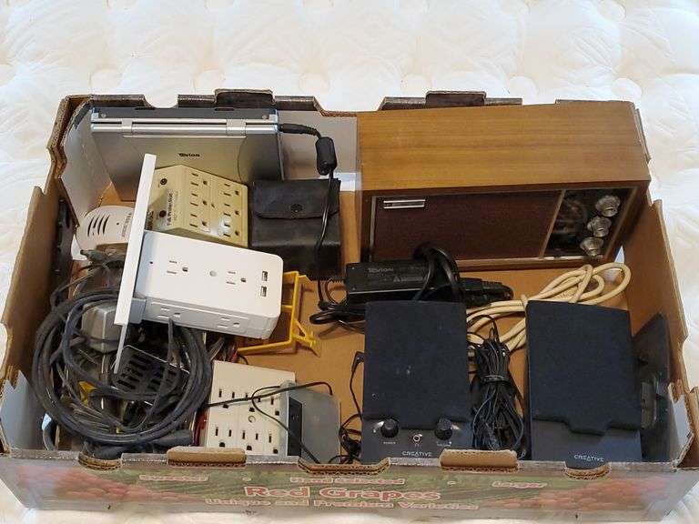 Box of assorted electronics including multi outlets, computer speakers ...
