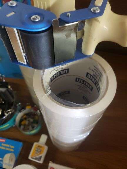 Assorted office accessories including Uline packing tape, tape guns ...