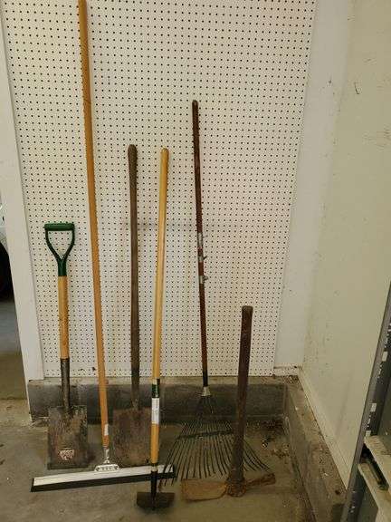 Lot of yard tools including shovels, rake, squeegee, Maddox pic axe ...