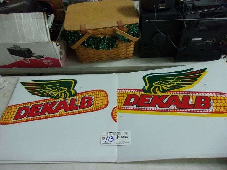 Pair of DeKalb corrugated signs, 24" x 20" - Backes Commercial Auctioneers