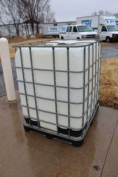300 gallon poly tank with cage - Backes Commercial Auctioneers