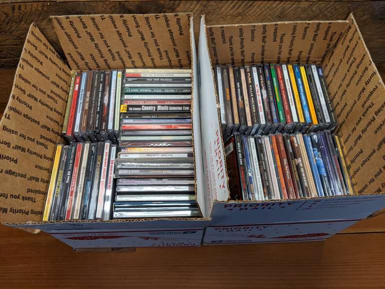 2 boxes of cds (mostly country) - Bid On Estates Auction Services