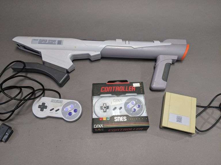 SNES Super Scope and Sensor (missing eyepiece and battery cover) plus 2 controllers. Includes ...