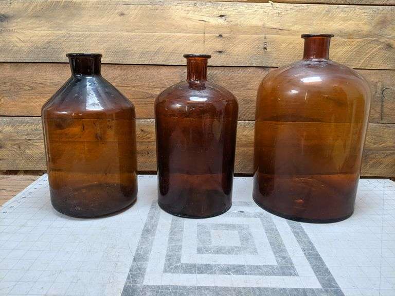 3 Large Brown Glass Bottles - Bid On Estates Auction Services