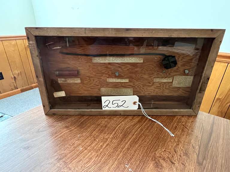 Shadowbox of misc crime artifacts - Bolinger Real Estate & Auction