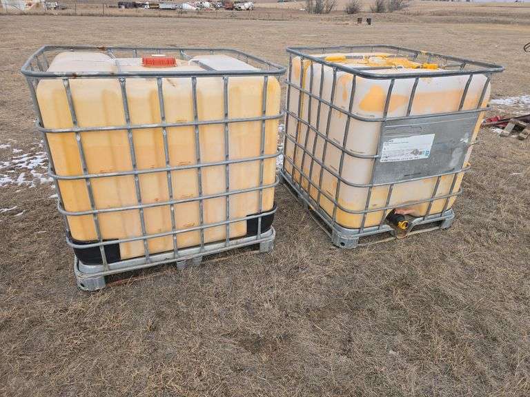 2- ~400GAL CHEMICAL TOTES THAT HAVE A GOOD AMOUNT OF YELLOW PAINT CAKED ...