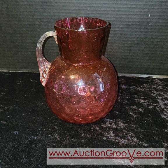 Cranberry glass pitcher. Has chipping along the rim, and handle. LR ...