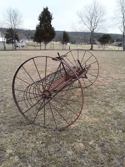 Farm Implement Hay Dump Rake, pull type, tall iron wheels, appears in ...