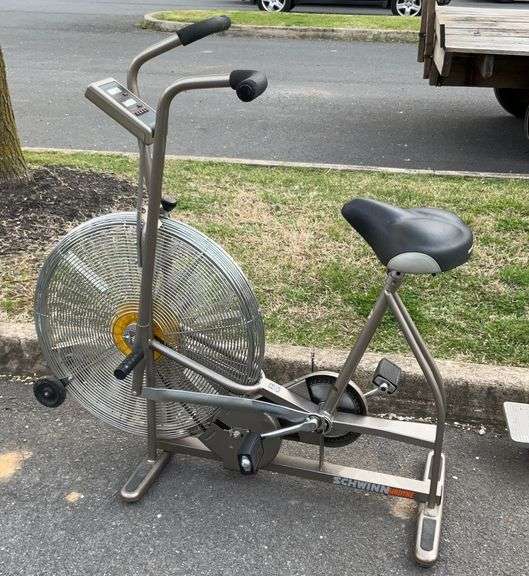 Schwinn Airdyne exercise cycle, located outside due to the overflowing ...