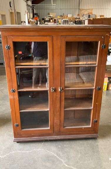 Early wood display cabinet with latchable glass doors on casters ...
